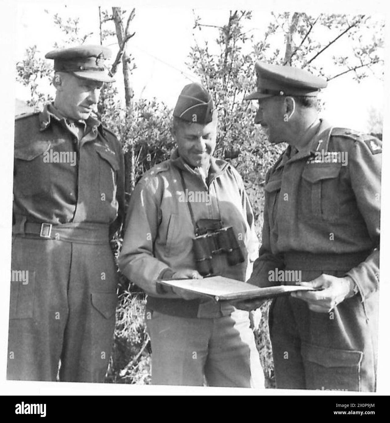 Photograph showing General Devers being briefed by General Allfrey and ...