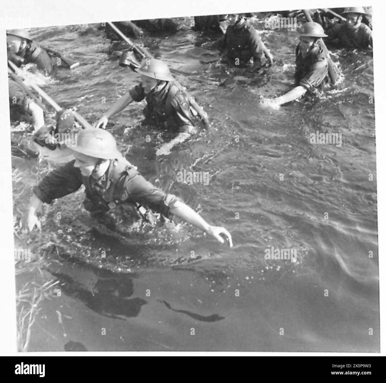 INFANTRY IN TRAINING - Troops wading ashore after crossing a river ...