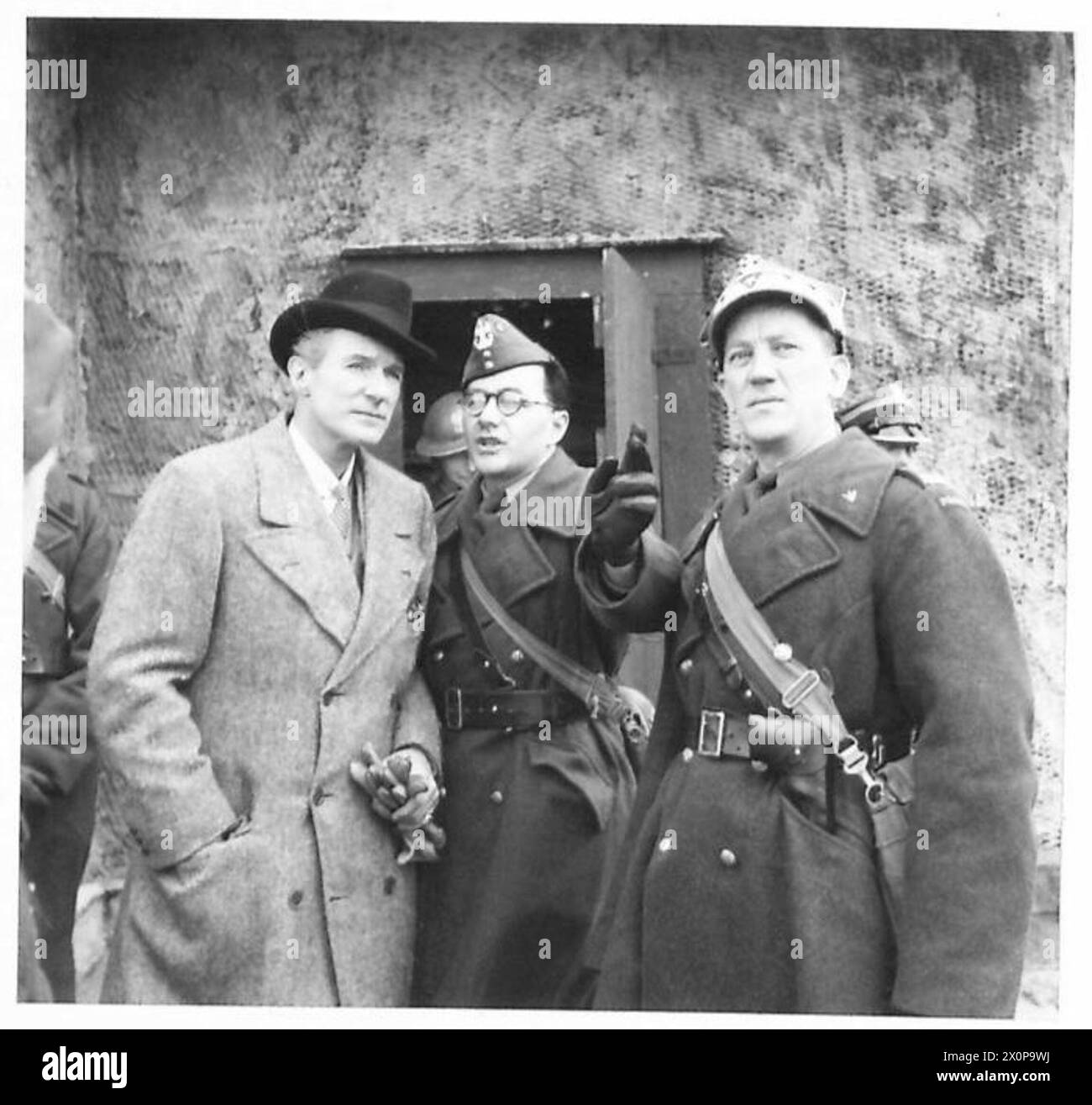 An officer of the 1st Rifle Brigade explains unit duties to American ...