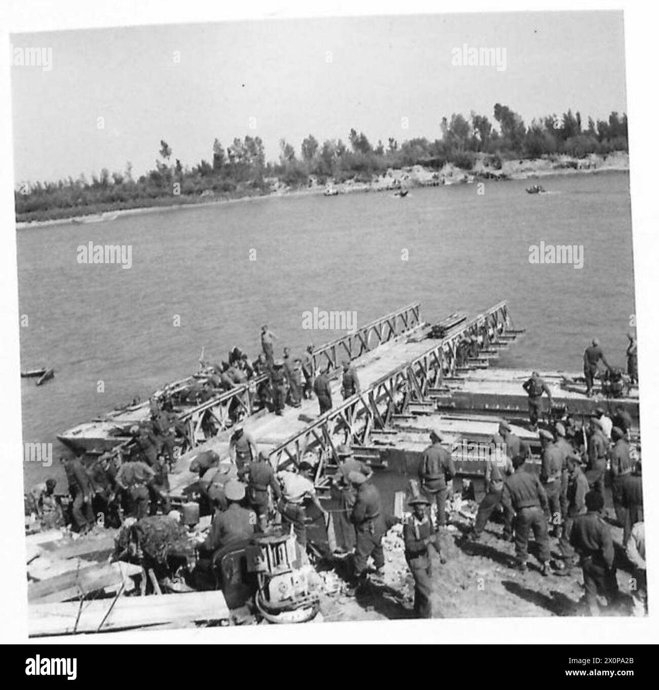 New Zealand sappers construct a floating pontoon bridge across the ...