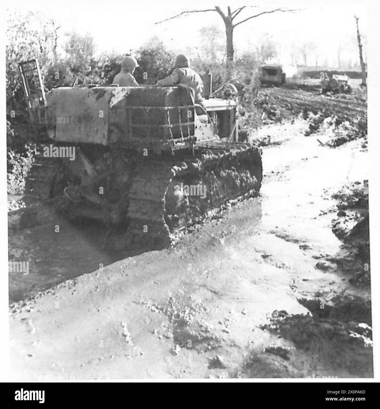 A bulldozer extracts a heavy lorry stuck in mud at the Fifth Army front ...