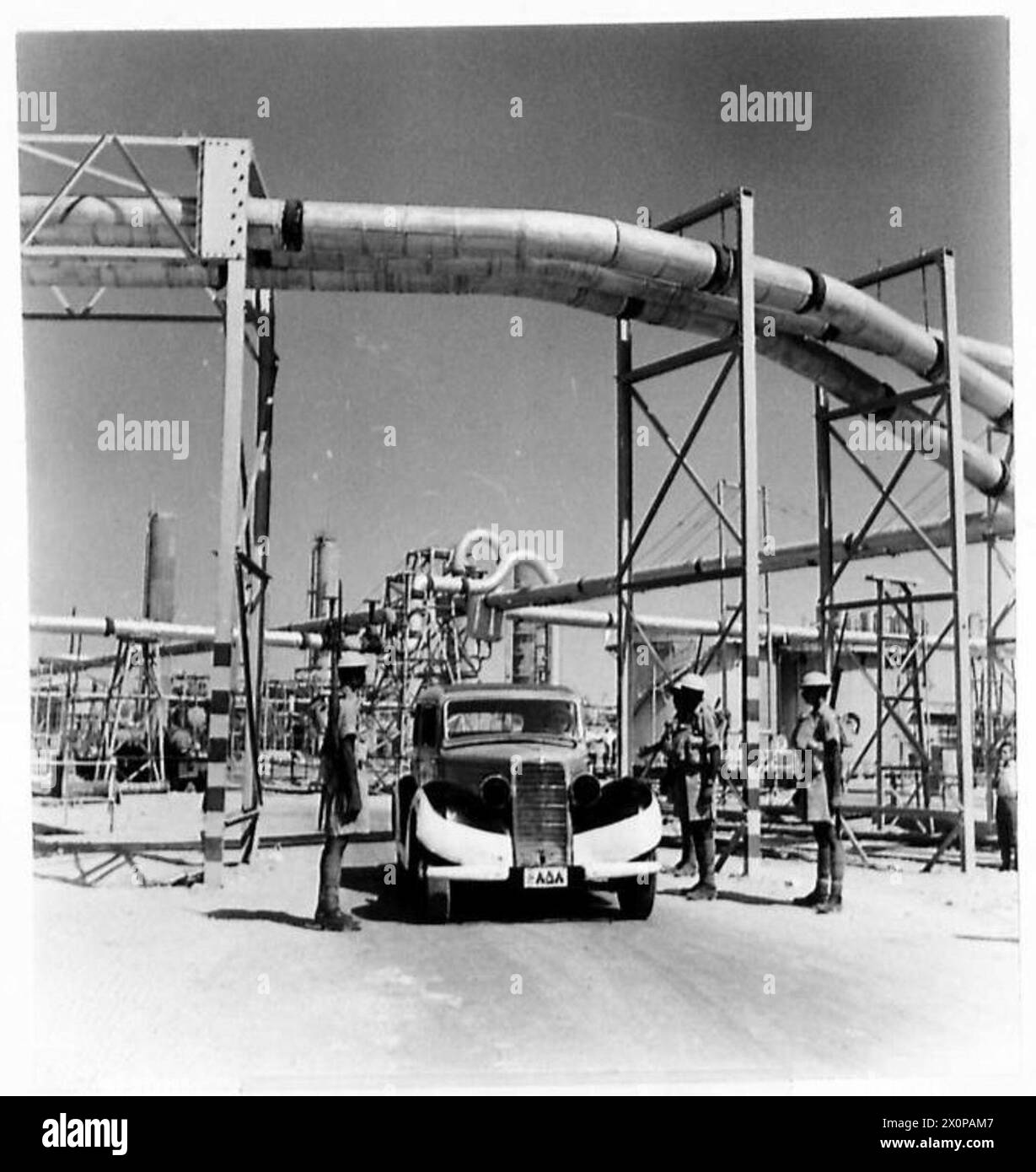 Indian riflemen inspect passes and vehicles at the entrance of a ...