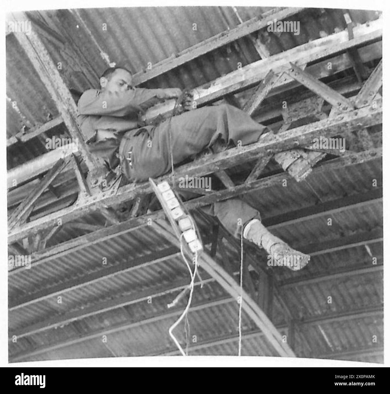 British Army personnel position a TNT charge among girders during ...