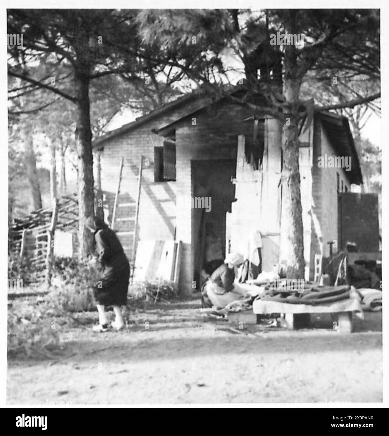 Partisans engage in daily activity around the cookhouse during military ...