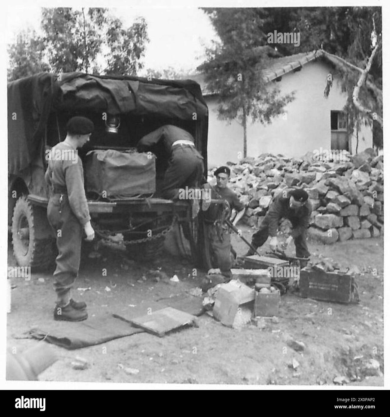 Troops of a British liaison regiment load equipment onto trucks for ...