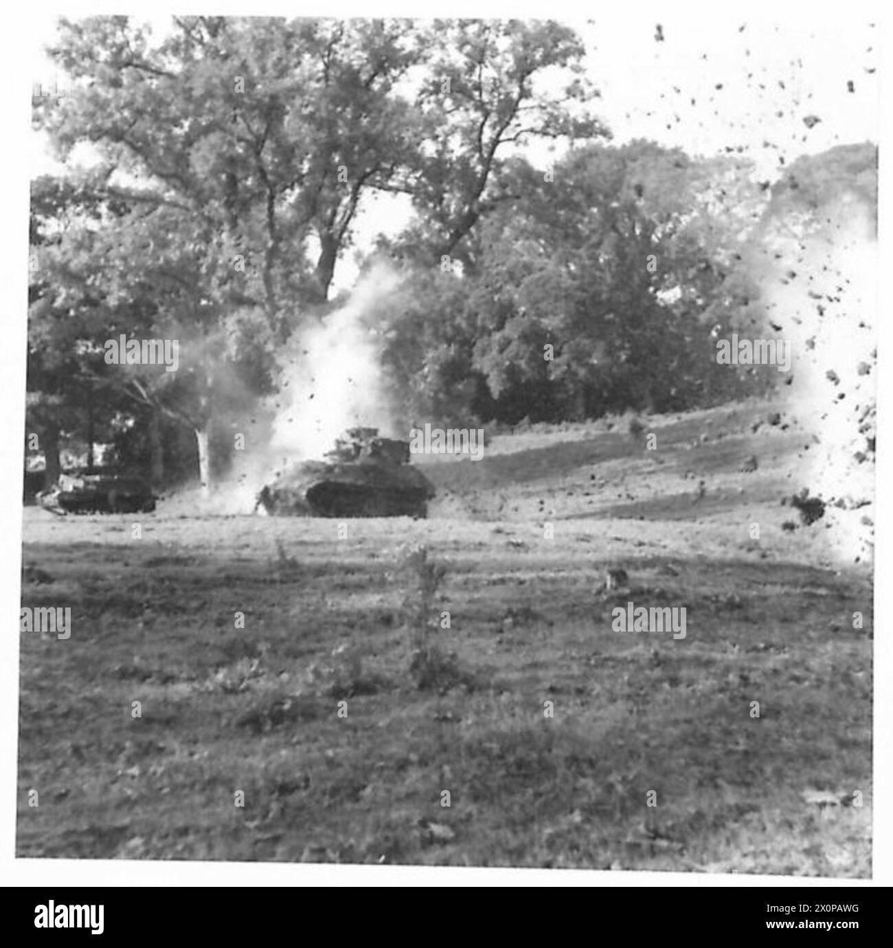 A light tank and a Bren carrier advance through a minefield during ...