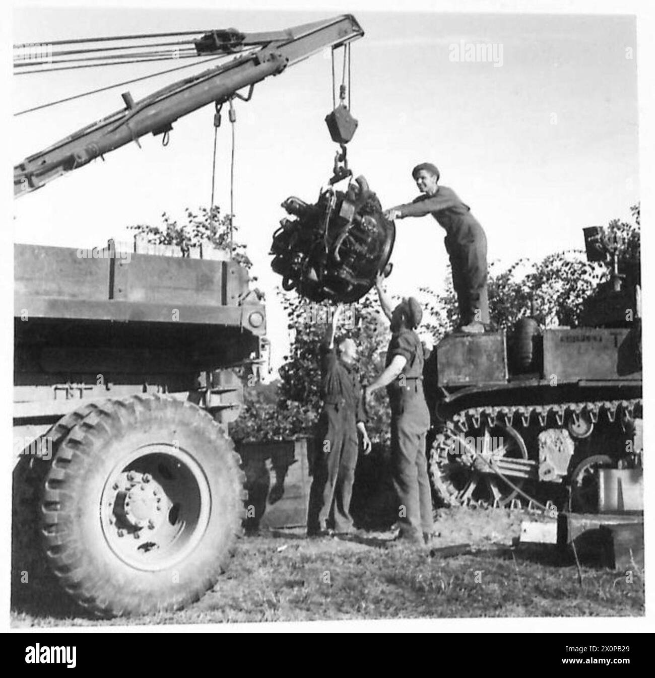 TANK RECOVERY AND REPAIR - A new tank engine being lifted into position ...