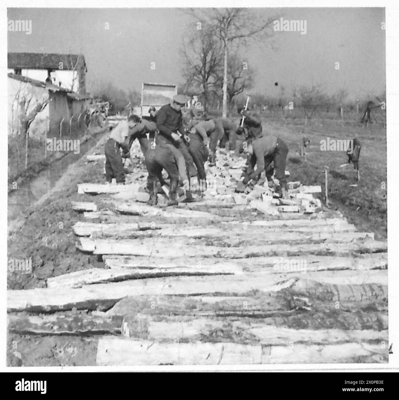 Eighth Army engineers construct a new road, leveling rubble and mud ...