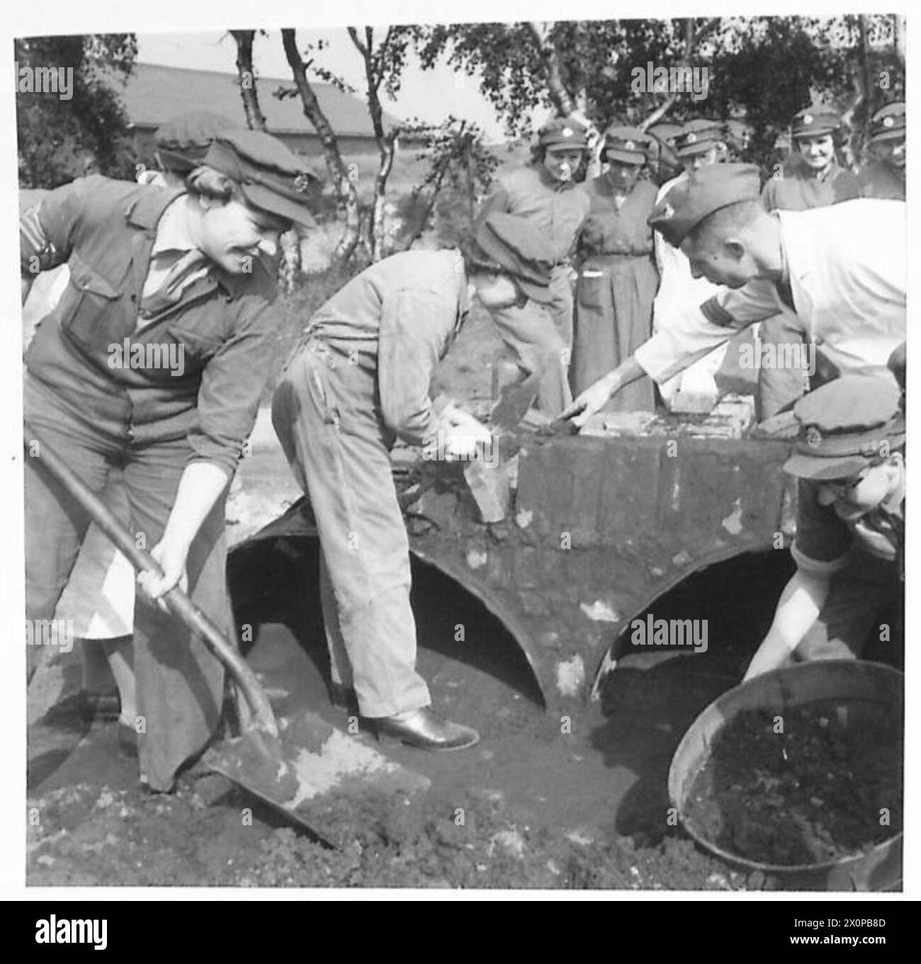 Members of the Auxiliary Territorial Service (ATS) train to construct a ...