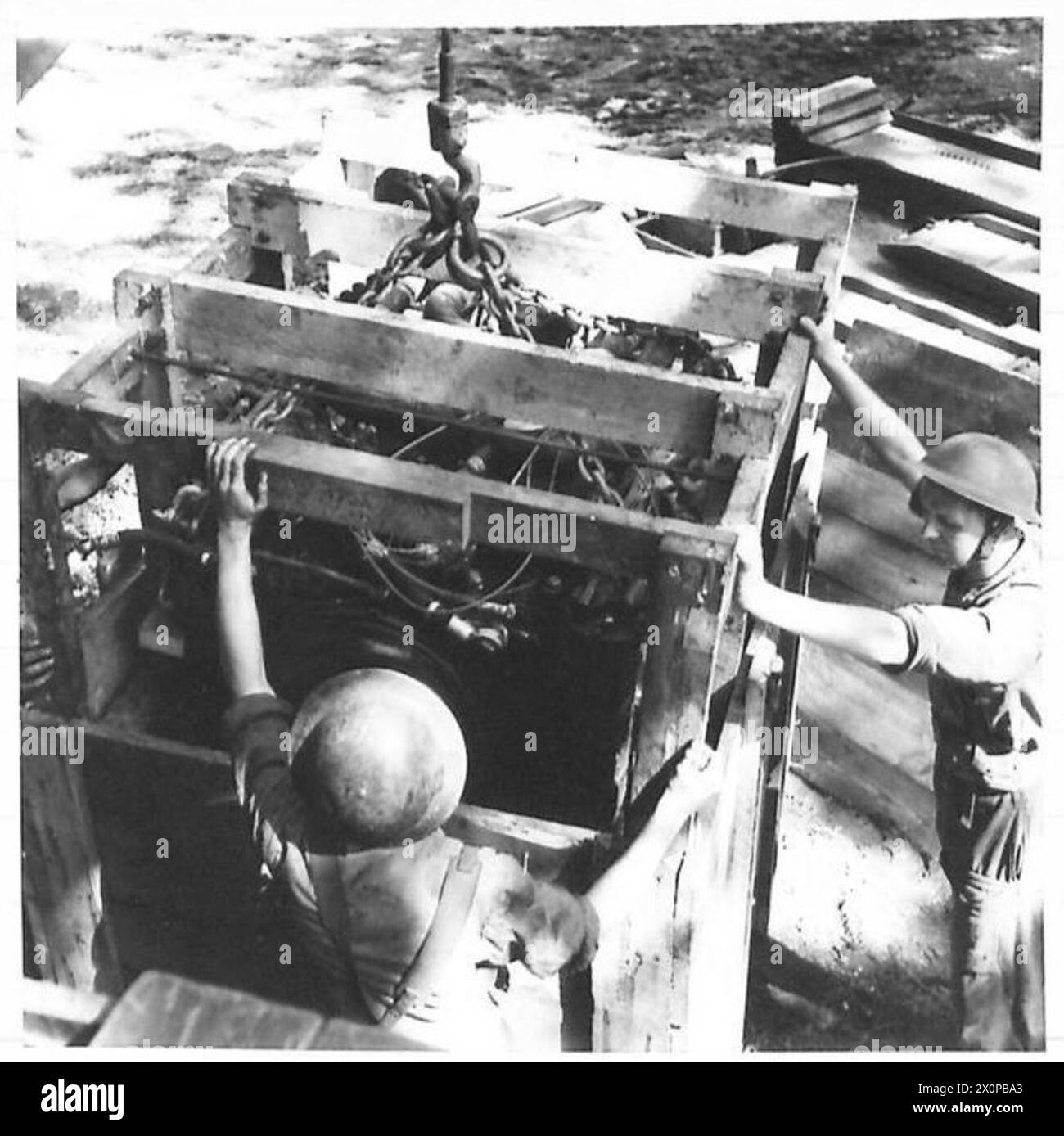 TANK RECOVERY AND REPAIR - A new replacement engine being lifted from ...