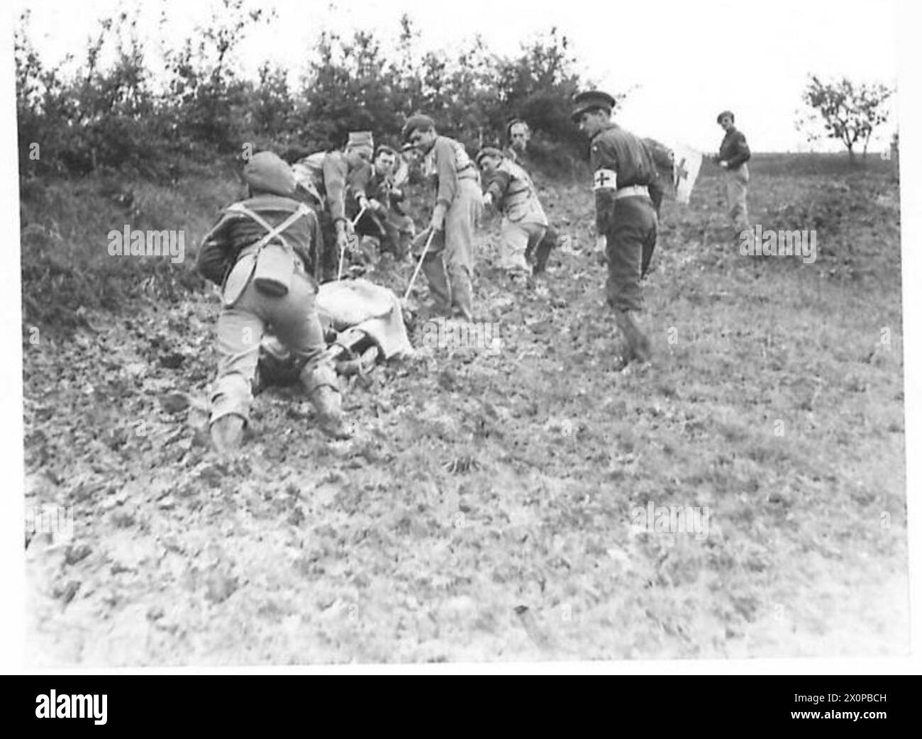 Stretcher bearers pause for rest while a Medical Officer attends to a ...