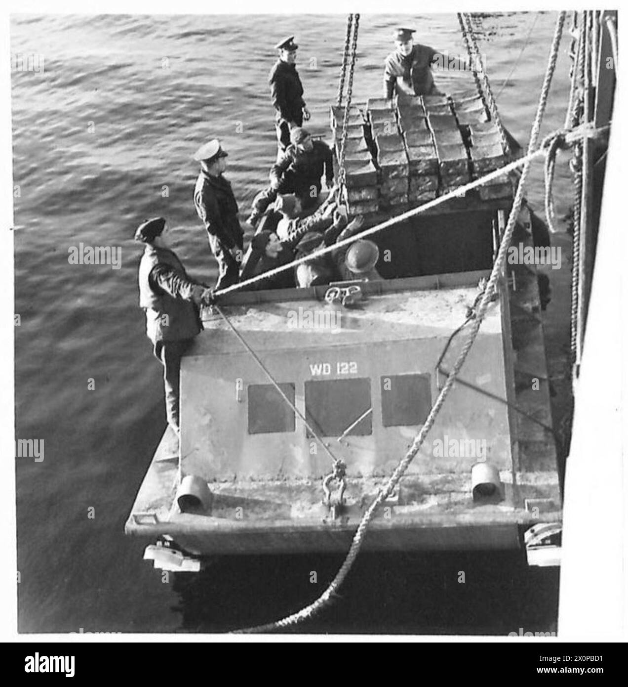 Photographic negative showing supplies being loaded into an amphibious ...