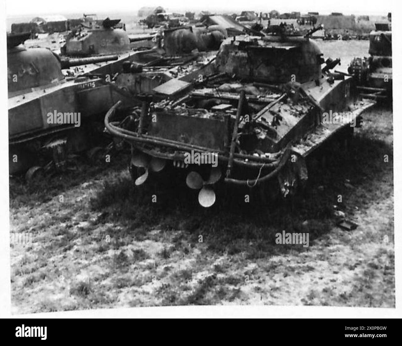 A DUMP FOR DAMAGED VEHICLES IN NORMANDY - An amphibious tank among the ...