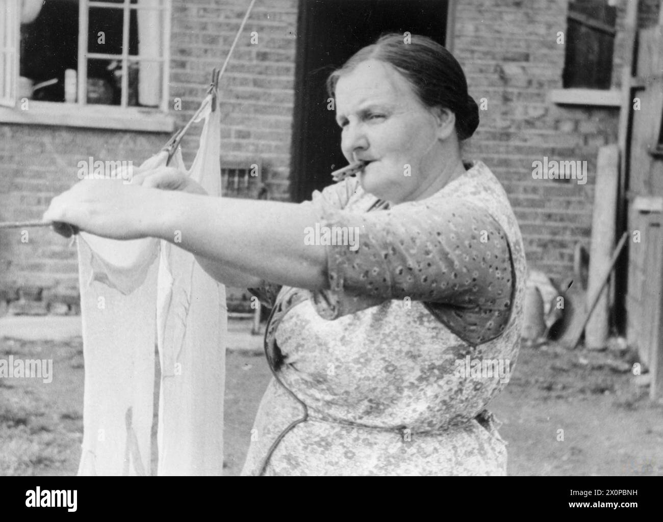 Mrs Suter hangs washing on a clothesline at the family home in Eltham ...