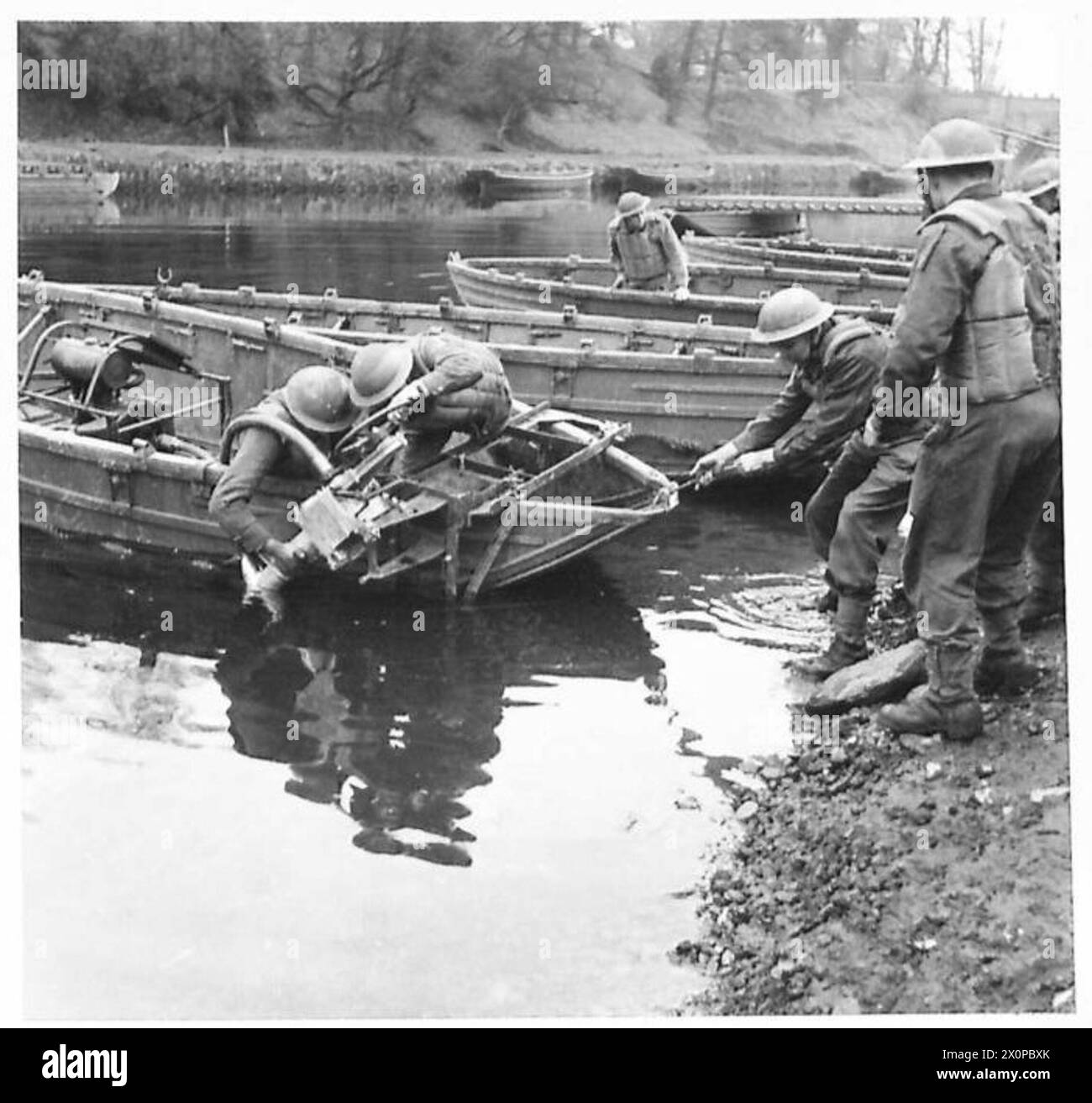 Correspondents observe Royal Engineers training as an outboard motor is ...