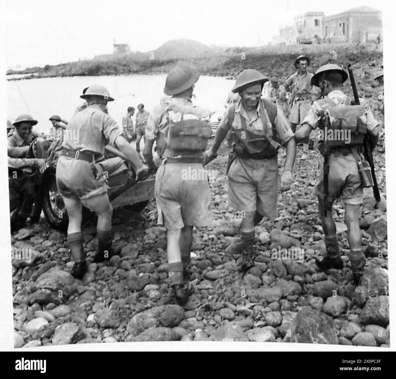 THE SURRENDER OF PANTELLARIA - Troops hauling equipment up a rocky ...