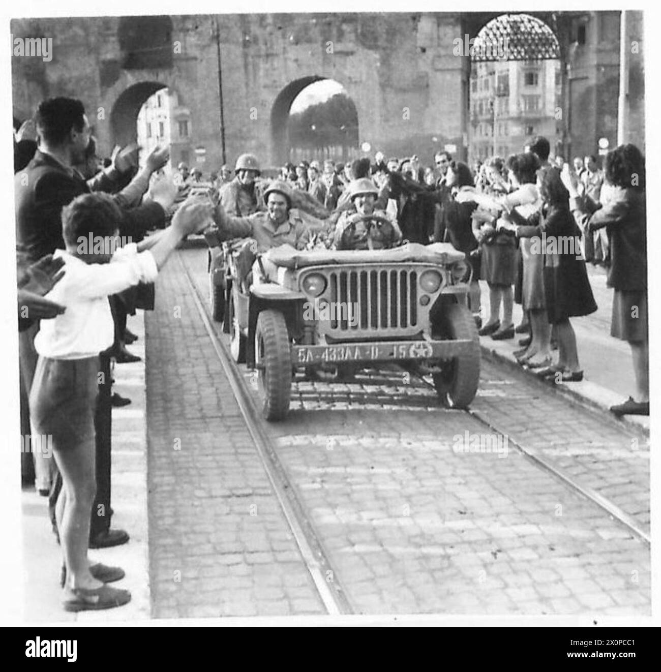 Photograph showing crowds cheering as Fifth Army troops pass through ...