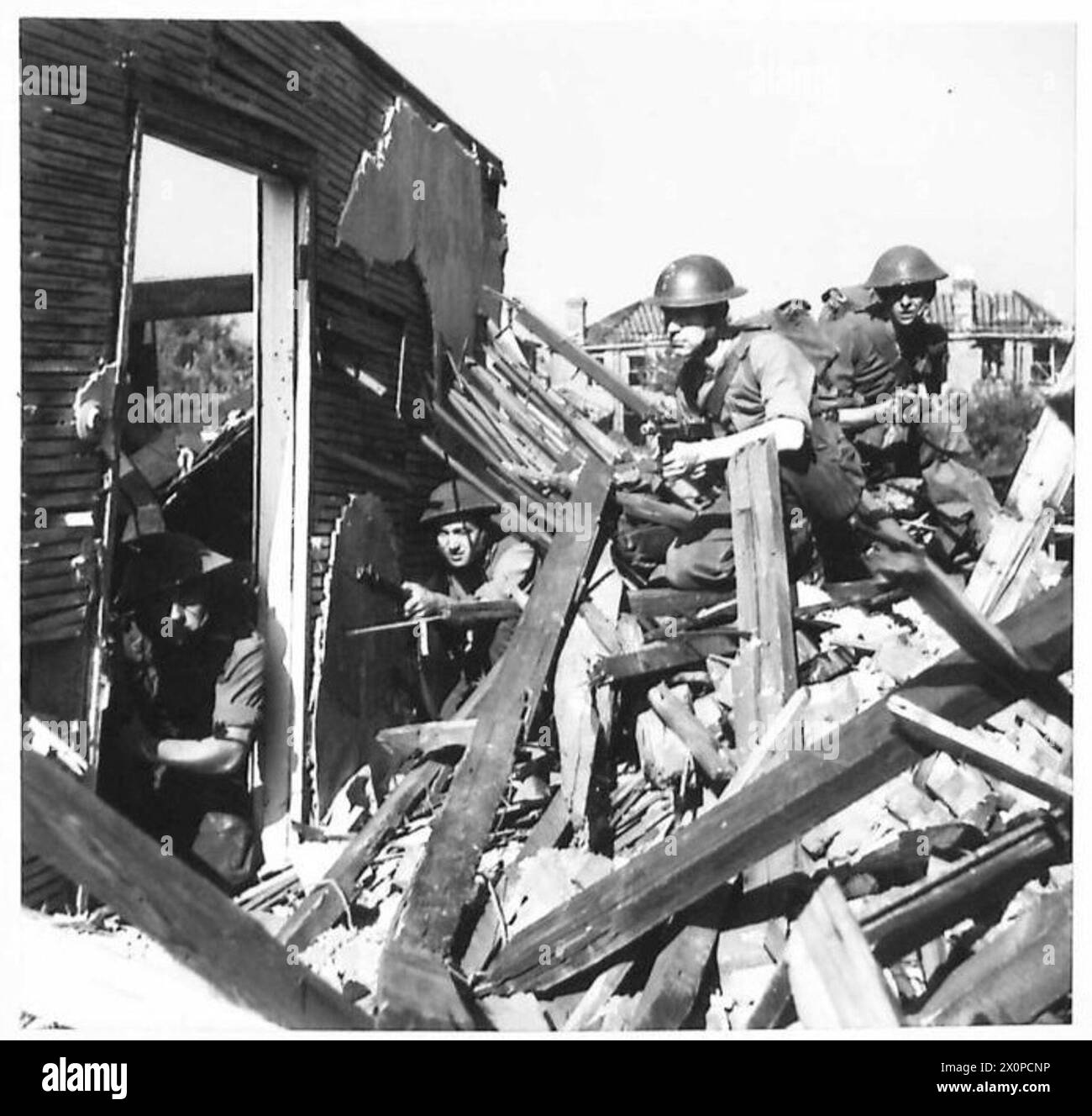A soldier practices house-to-house combat, moving over debris and ...