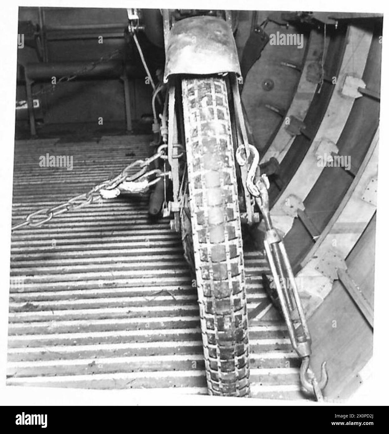 Motorcycles are lashed together inside a military glider, illustrating ...