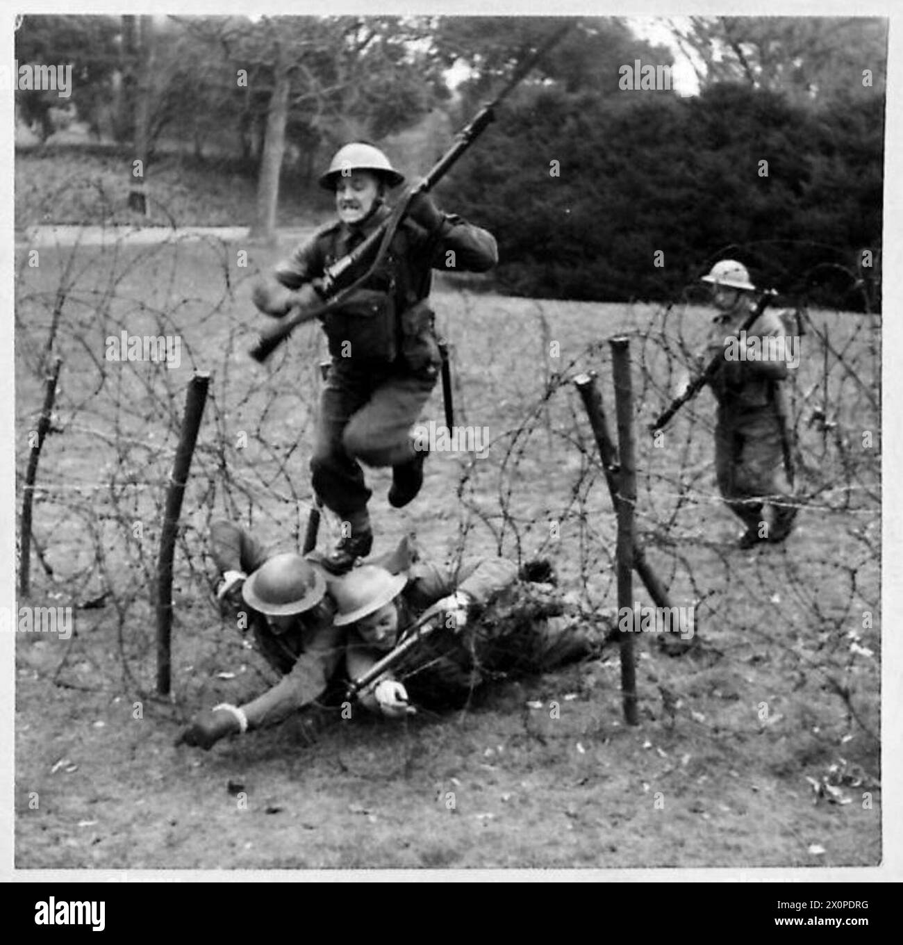 A NEW METHOD OF TACKLING BARBED WIRE OBSTRUCTIONS - Men following run ...