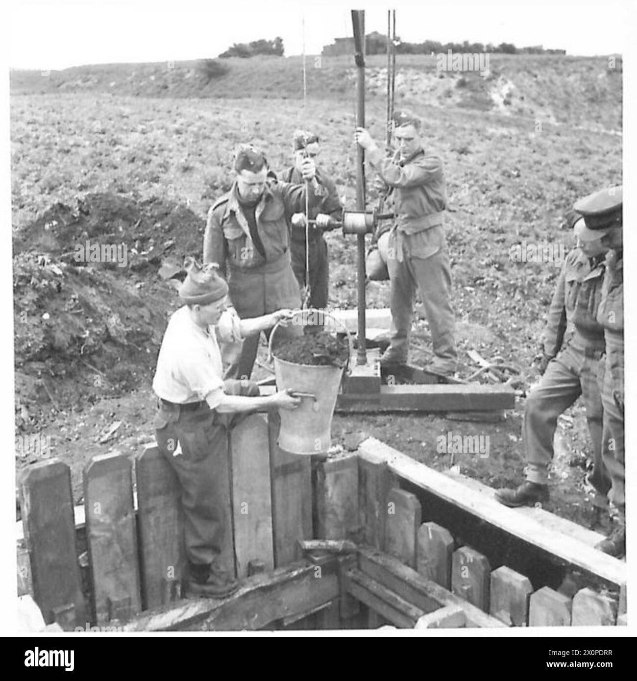 Home Guard personnel practice bomb disposal techniques using a dummy ...