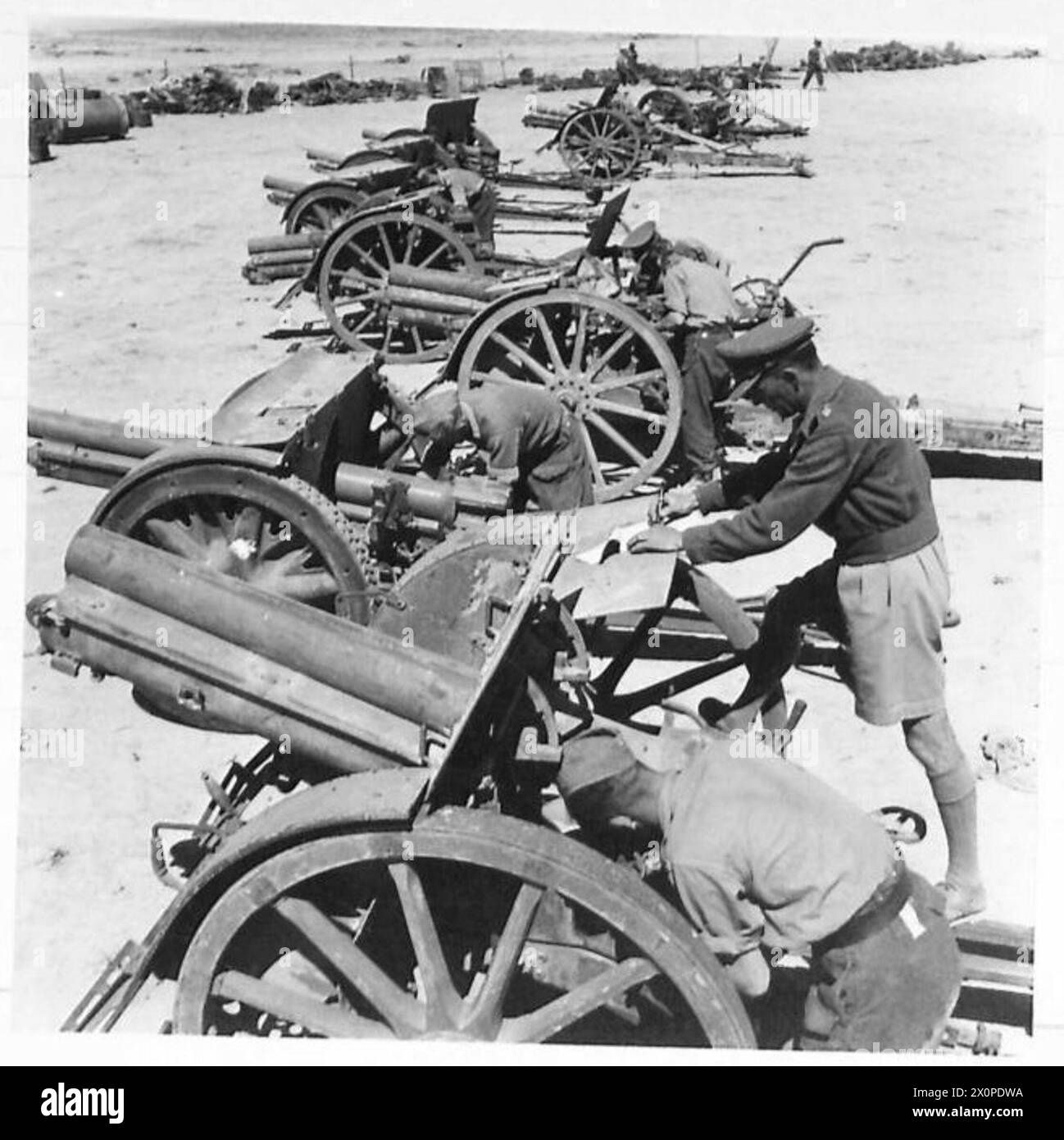 SALVAGE IN THE DESERT - These guns were captured from the enemy ...