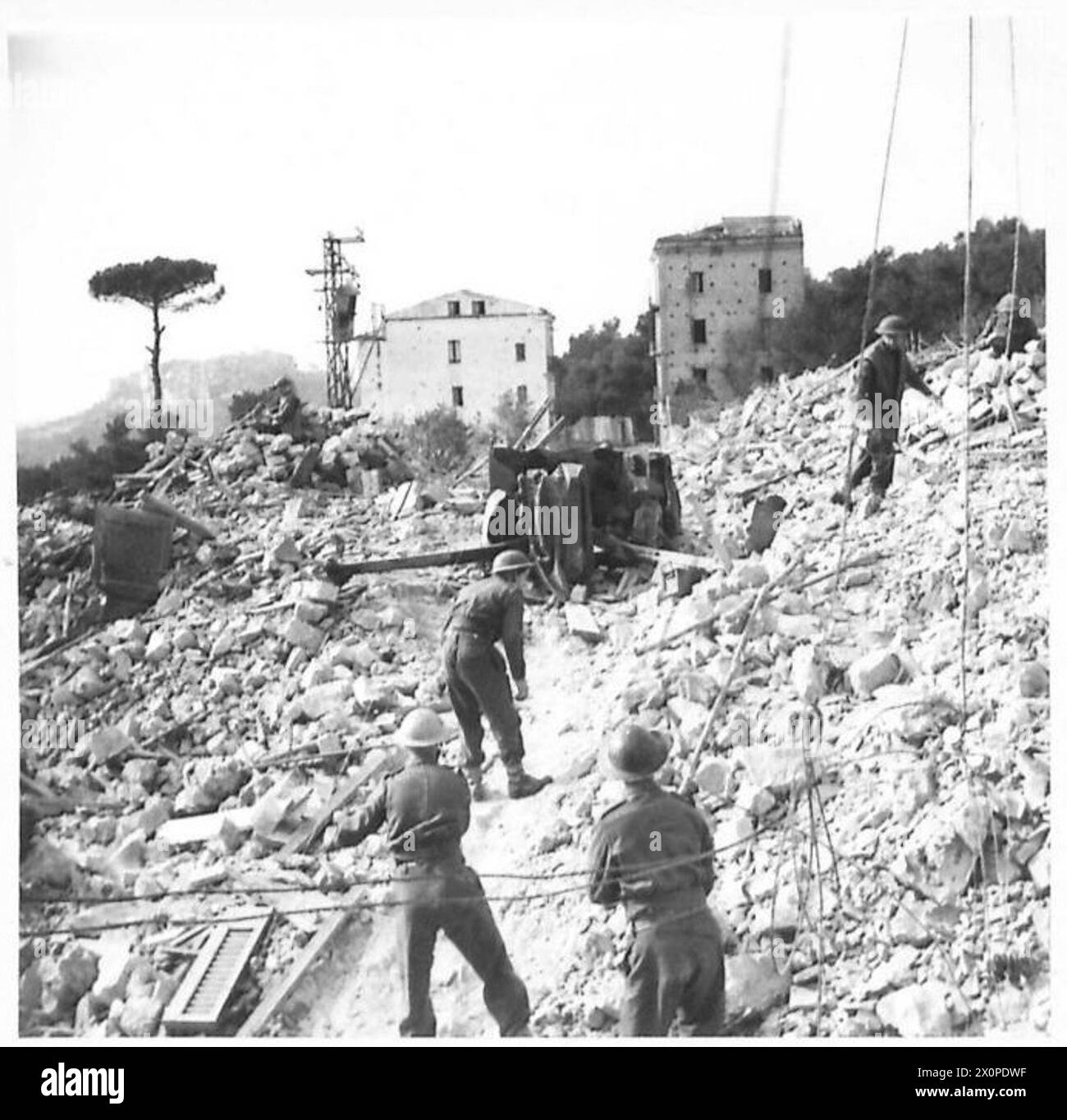 Infantrymen clearing a road through rubble in the ruined village of ...