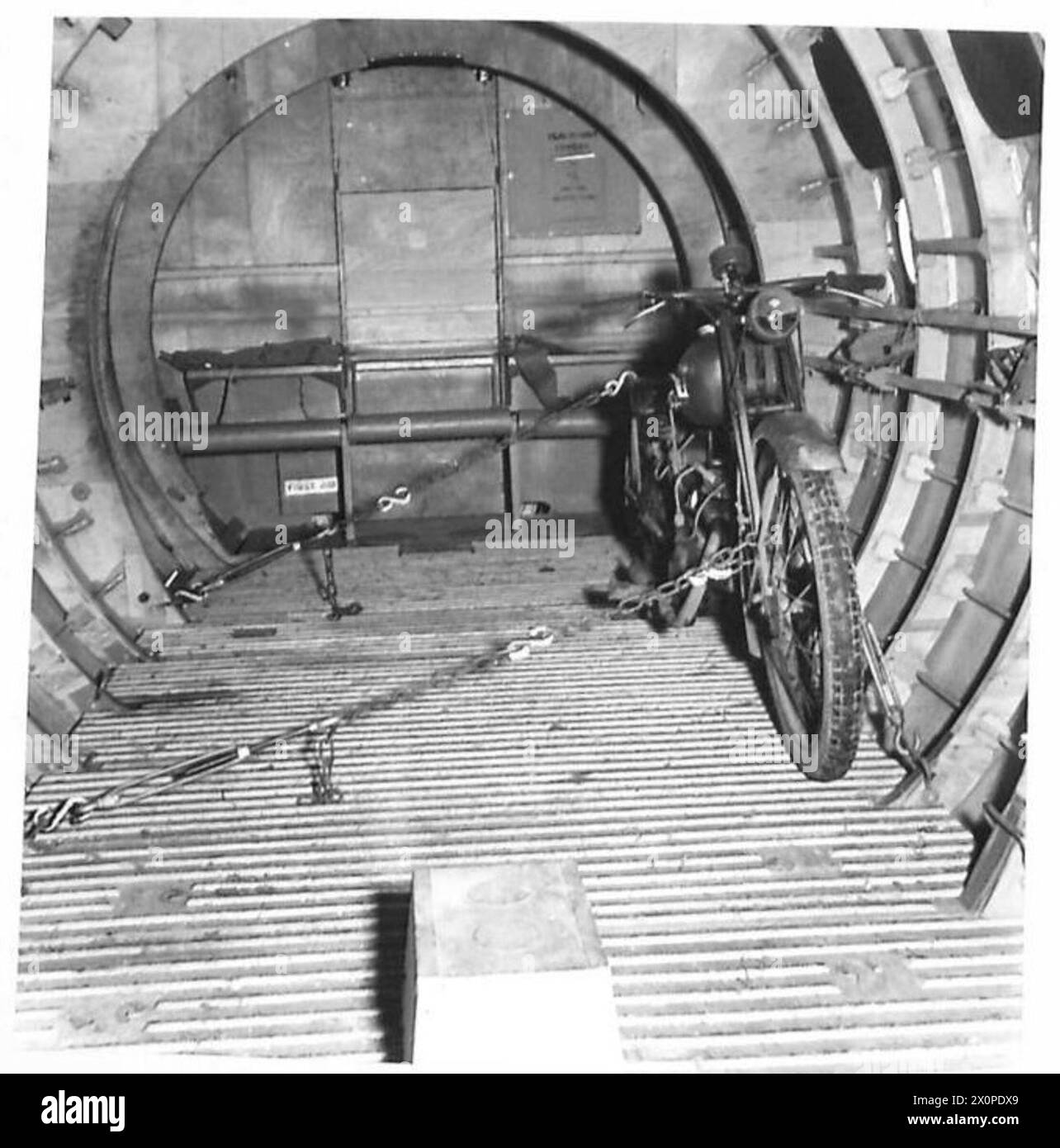 Motorcycles are lashed together inside a glider for transport ...