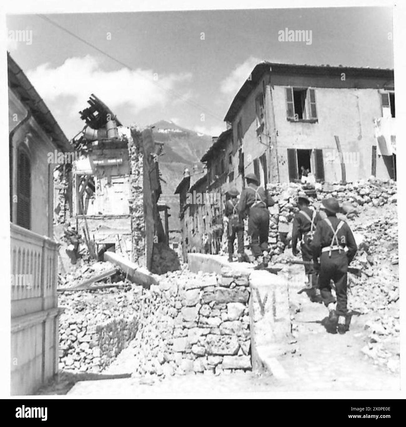 Scots Guards advancing through an Italian town to forward positions ...
