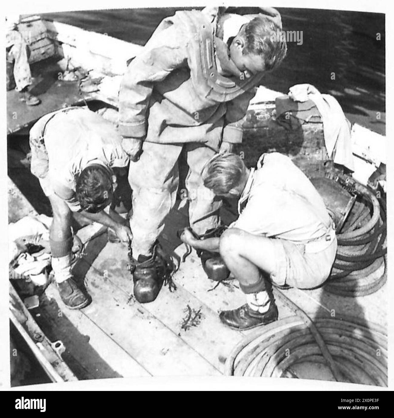 DIVING OPERATIONS BY ROYAL ENGINEERS - Fixing the heavy diving boots ...