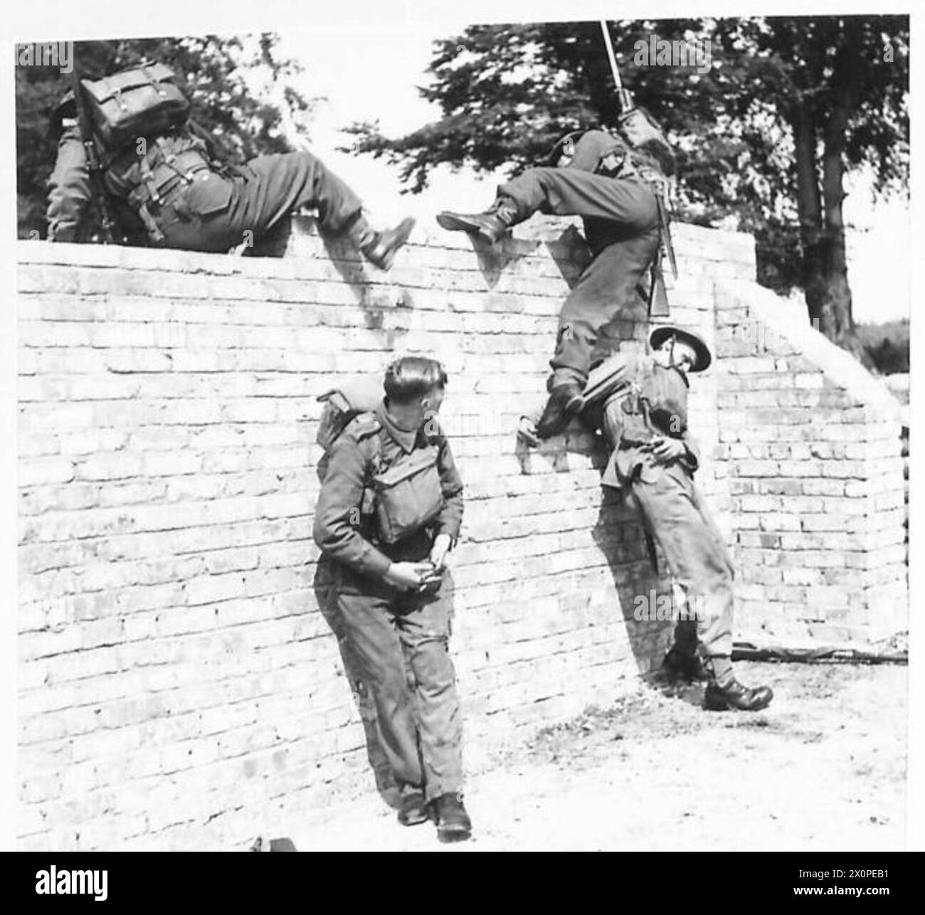 INFANTRY IN TRAINING - Troops clearing a high brick wall. Part of a ...