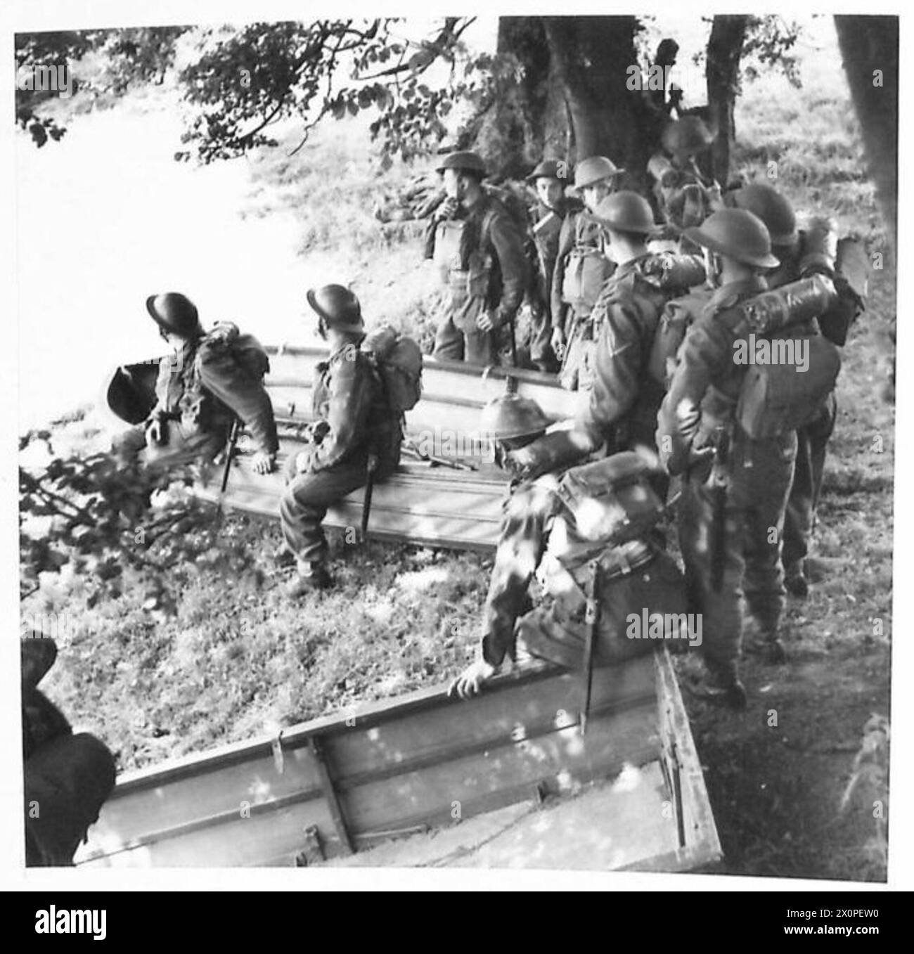 Royal Marines bring assault boats to a river crossing during a combined ...