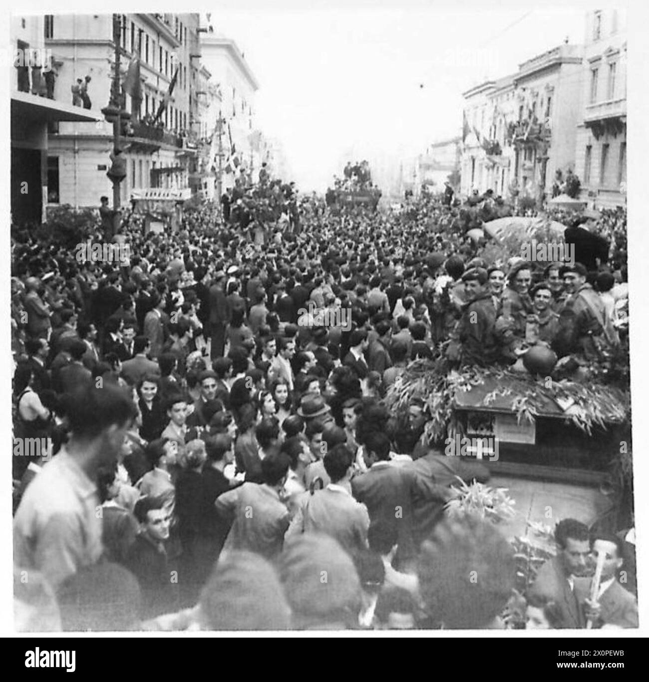 BRITISH PARATROOPS ENTER ATHENS - A flower-covered jeep almost hidden ...