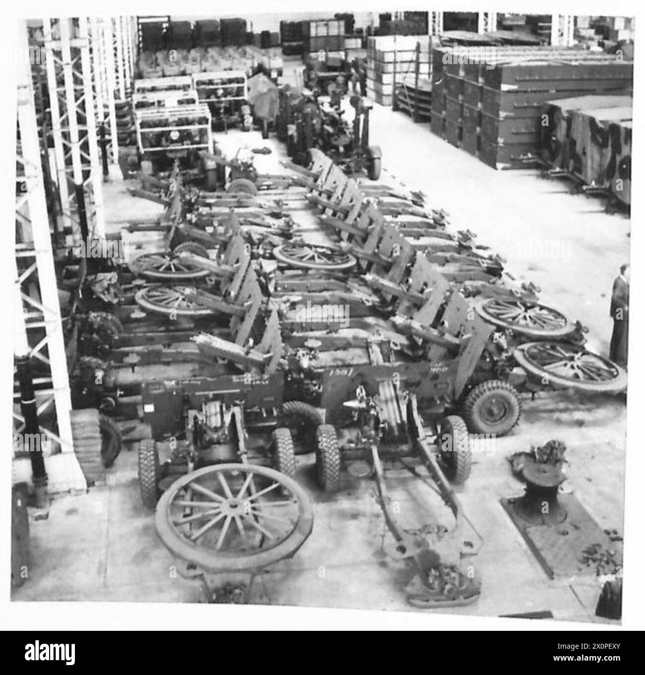 IN AN ORDNANCE DEPOT - A view in one of the sheds showing gun carriages ...