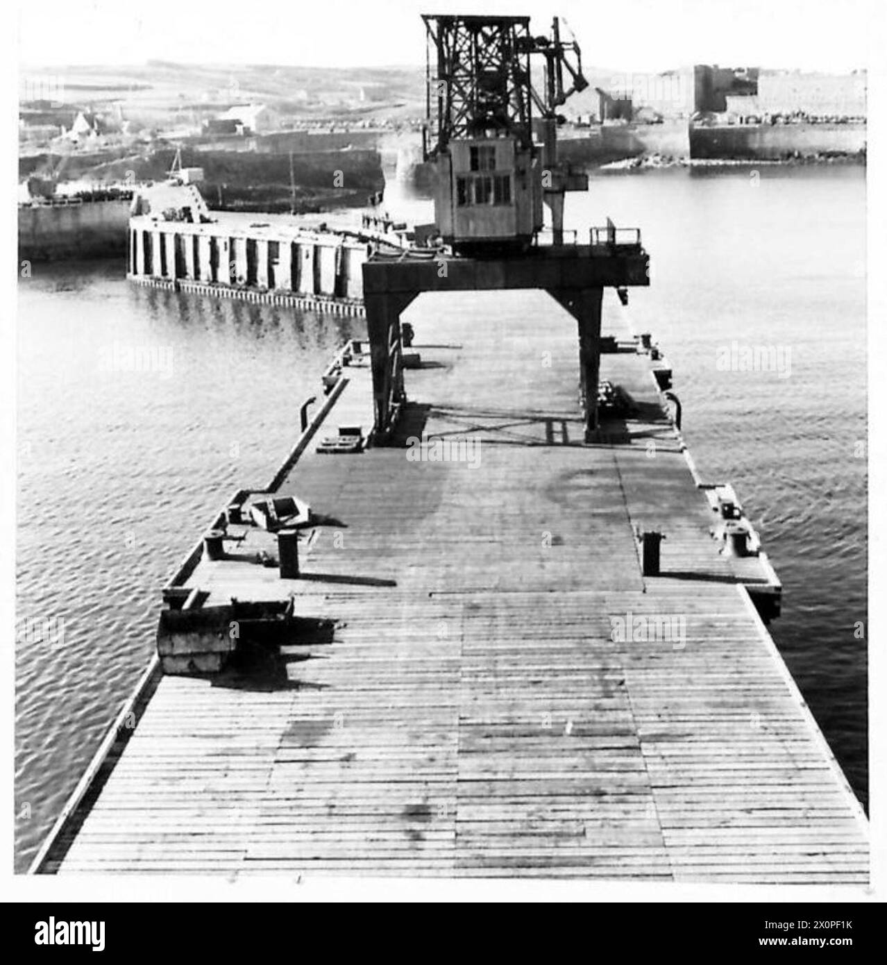 Photographs at Alderney, Channel Islands, show a German-built jetty and ...
