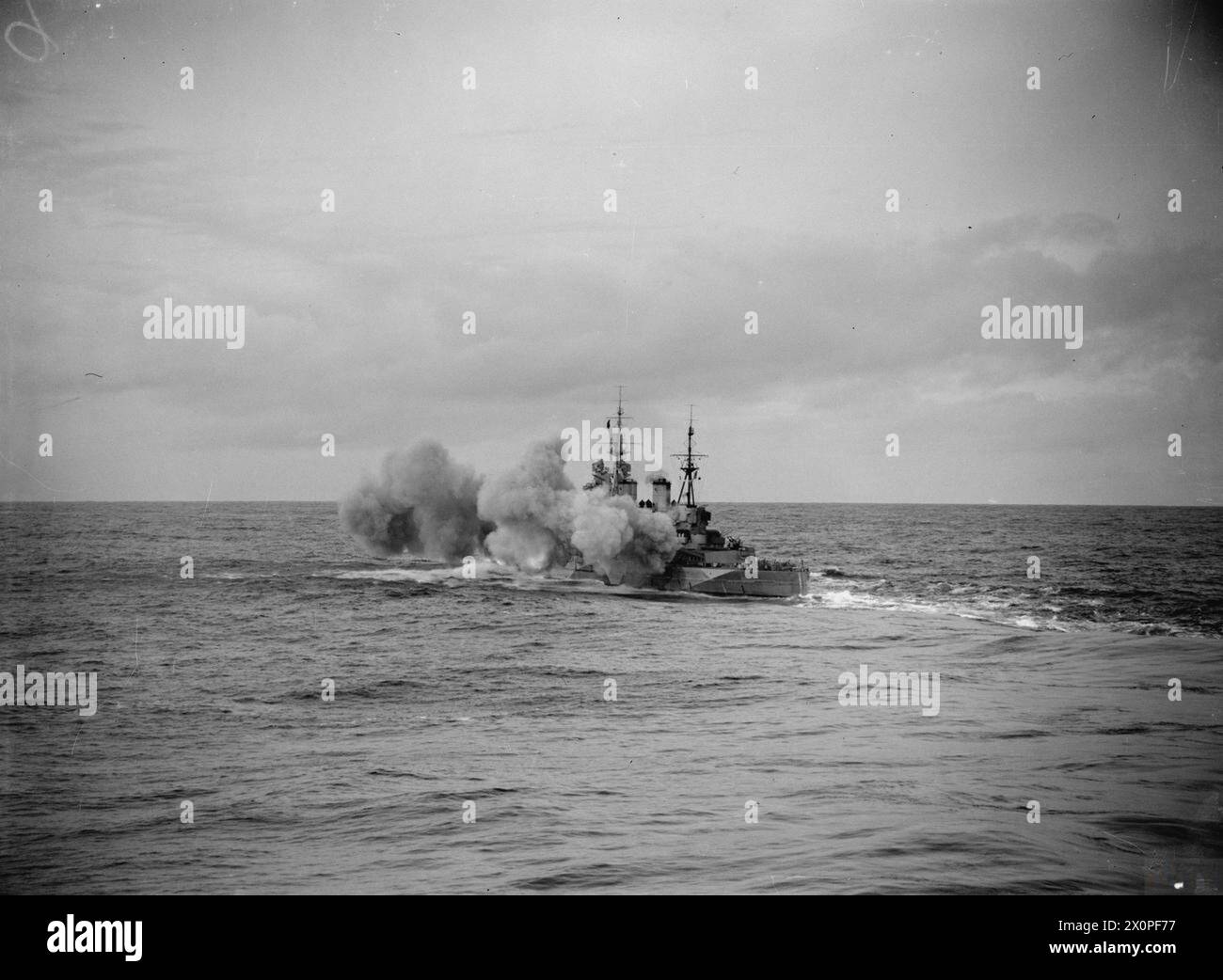 HMS Howe fires her 14-inch guns in Scapa Flow on 17 October 1942, alongside HMS King George V ...