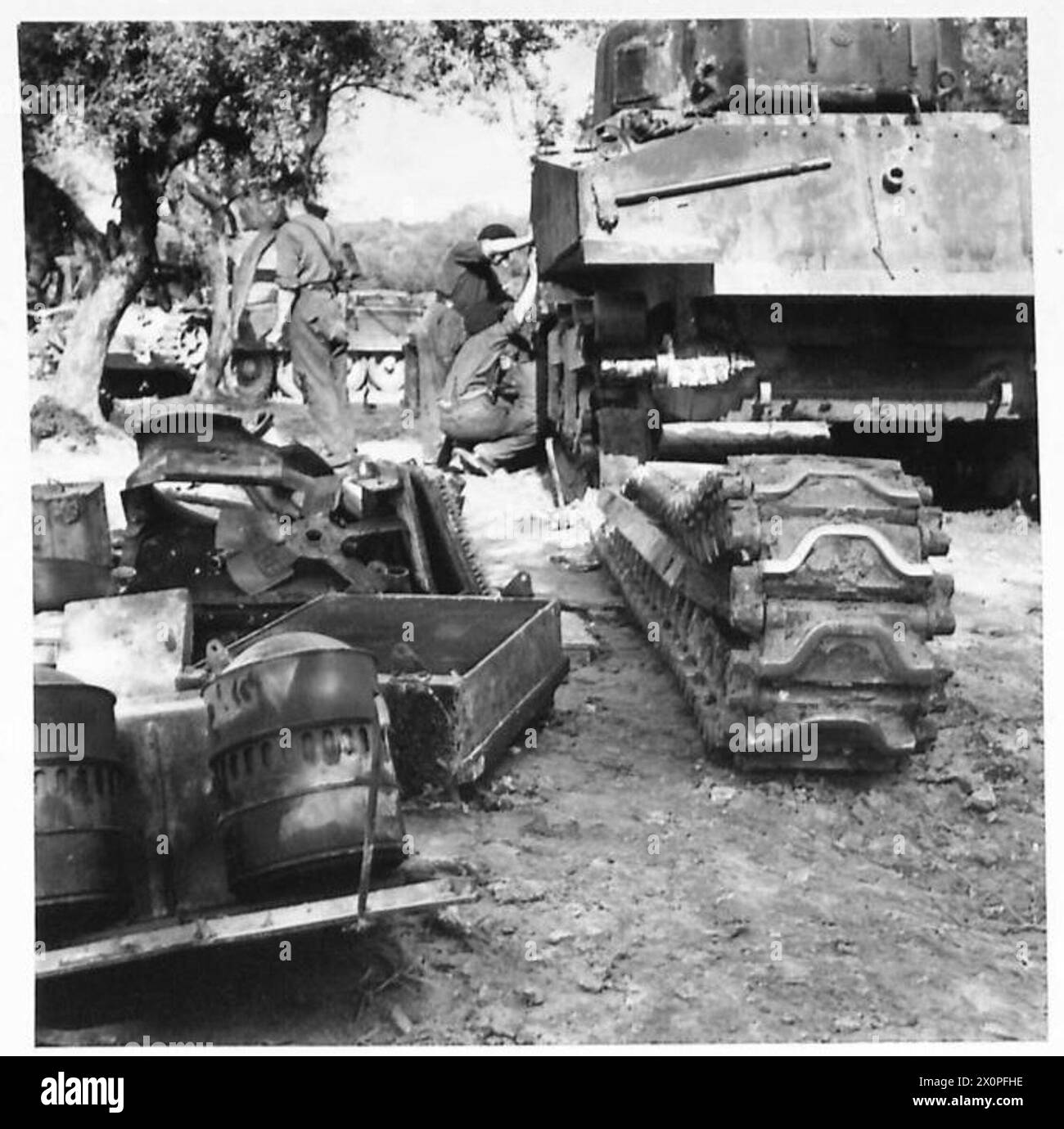 AMERICAN SHERMAN TANK REPAIRS BY R.E.M.E. - A tank track being repaired ...