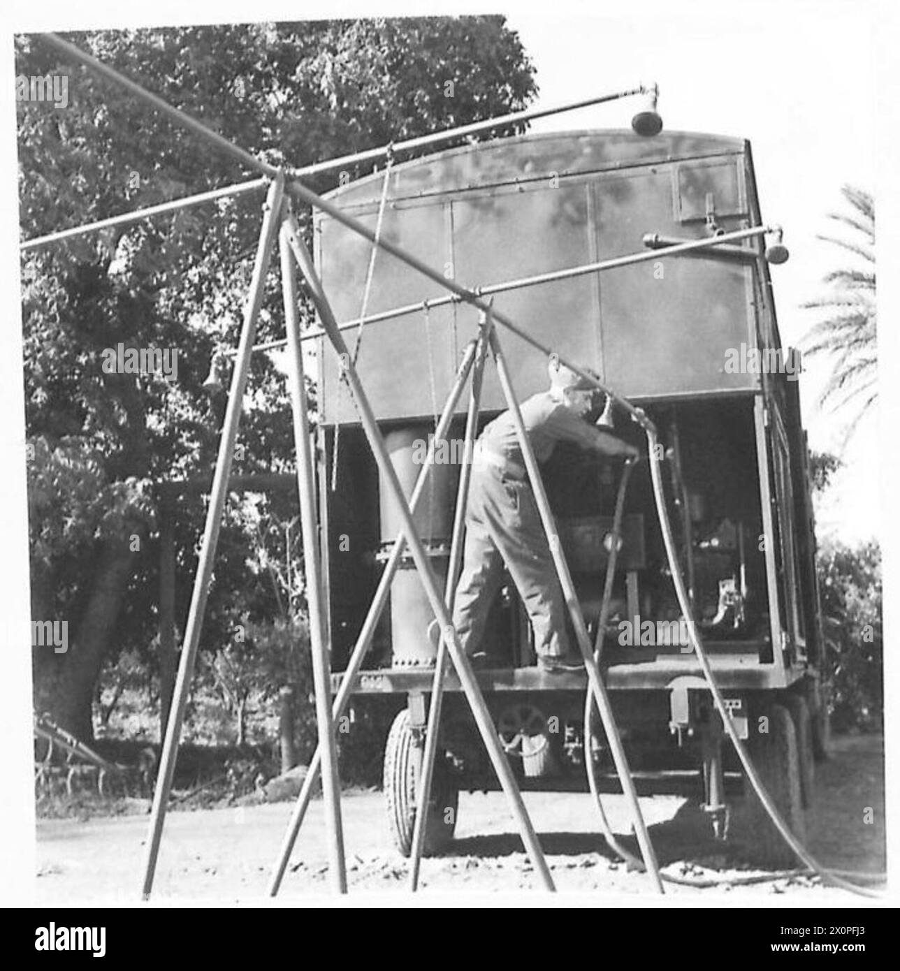 Pte. J. Perry installs personnel showers on a mobile trailer laundry ...