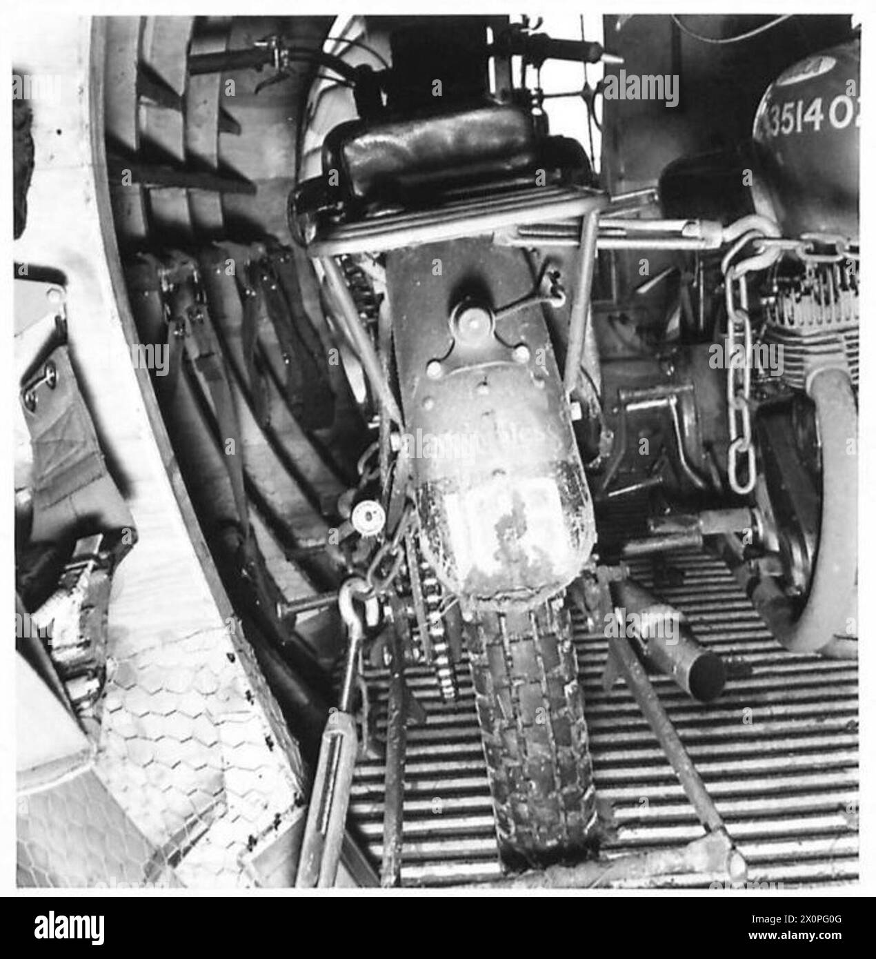 Motorcycles are lashed together inside a military glider for transport ...