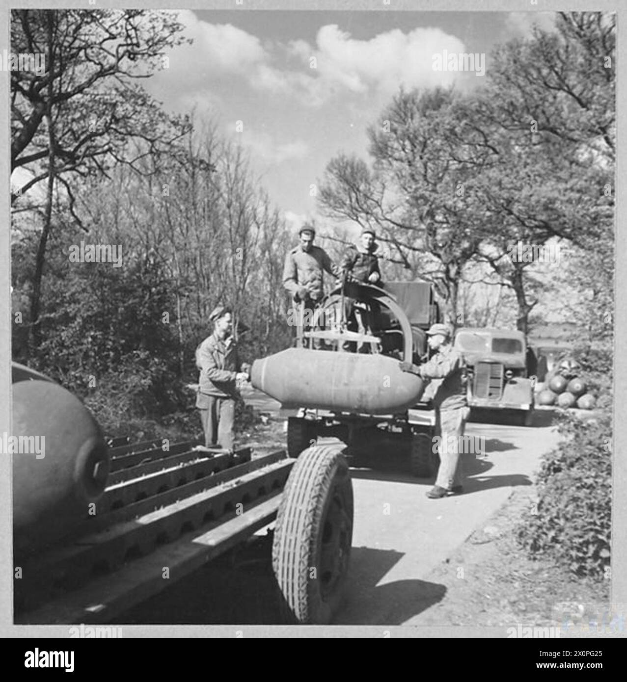 The photograph depicts a bomb dump located in a small copse during 1944 ...
