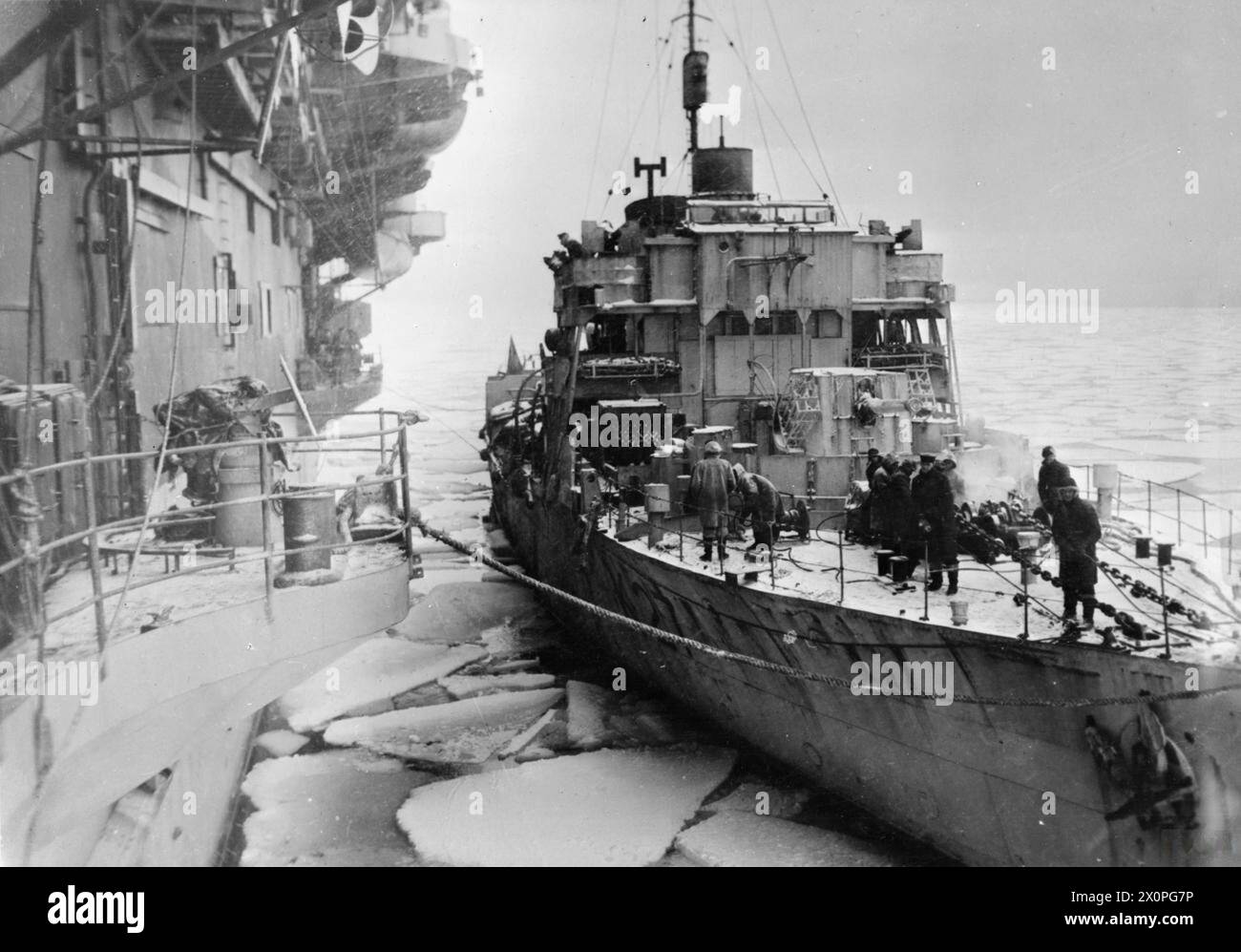 HMS Honeysuckle, a Flower-class corvette, comes alongside aircraft ...