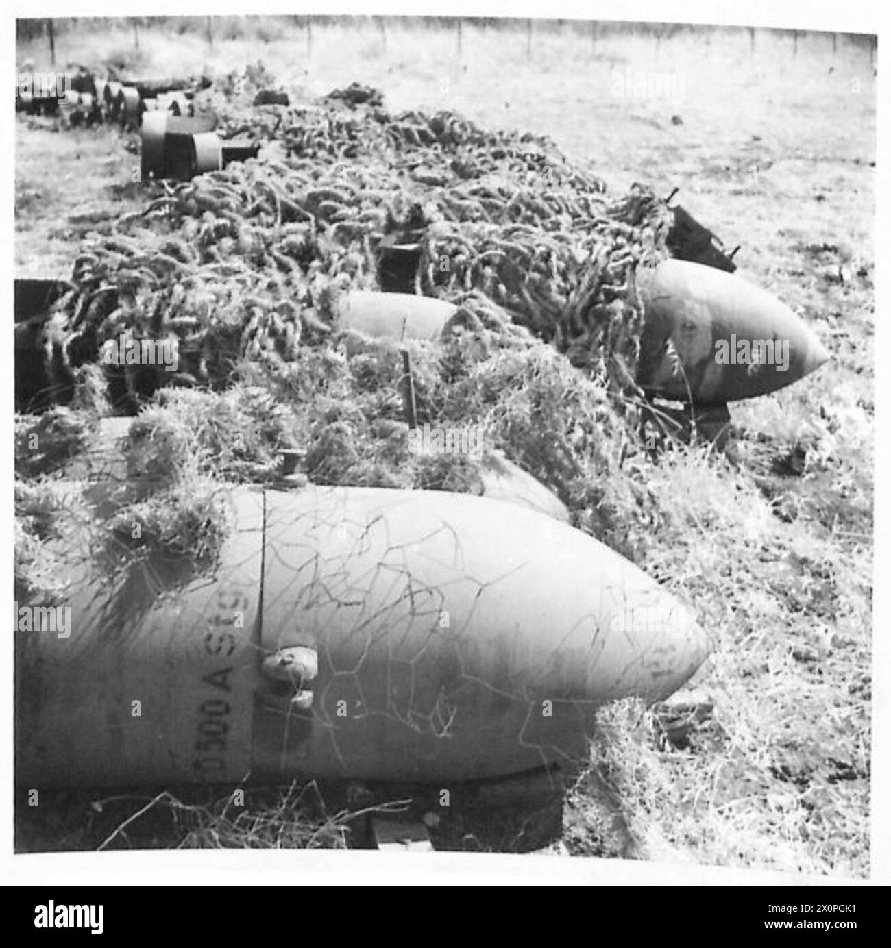 Bombs left by the enemy beneath camouflage on the Catania Plain ...