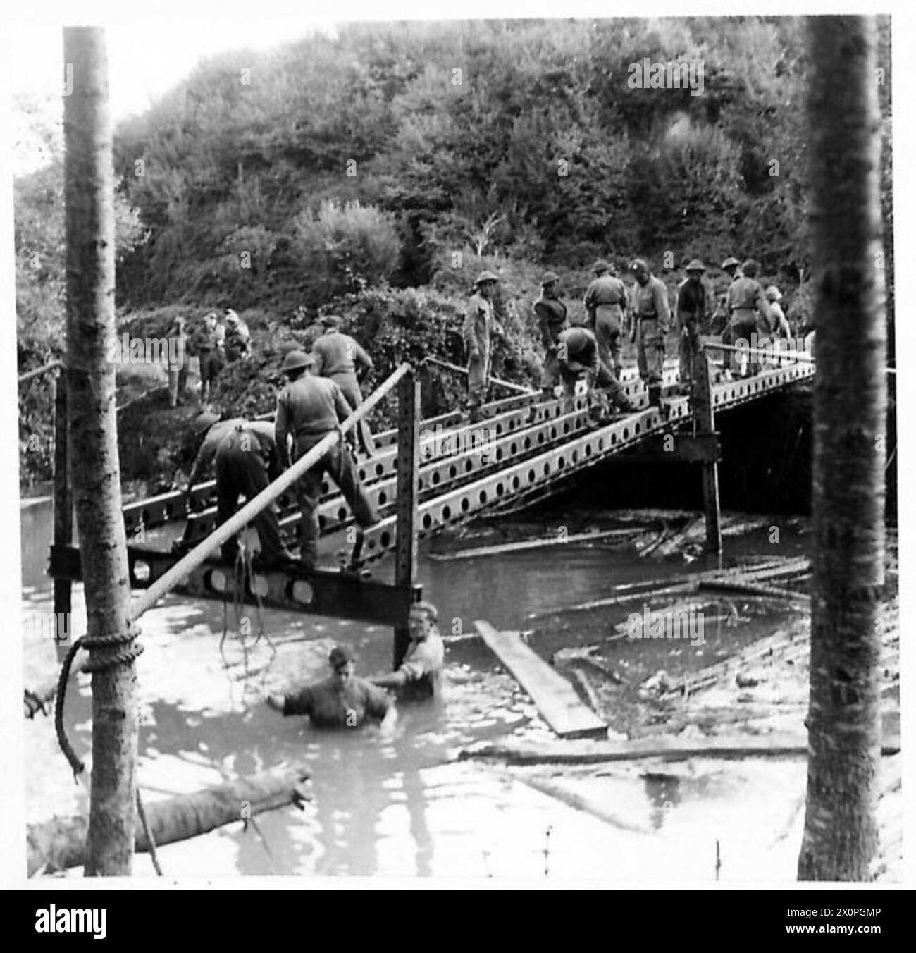 Sappers construct a bridge over the Teano Valley River, installing ...