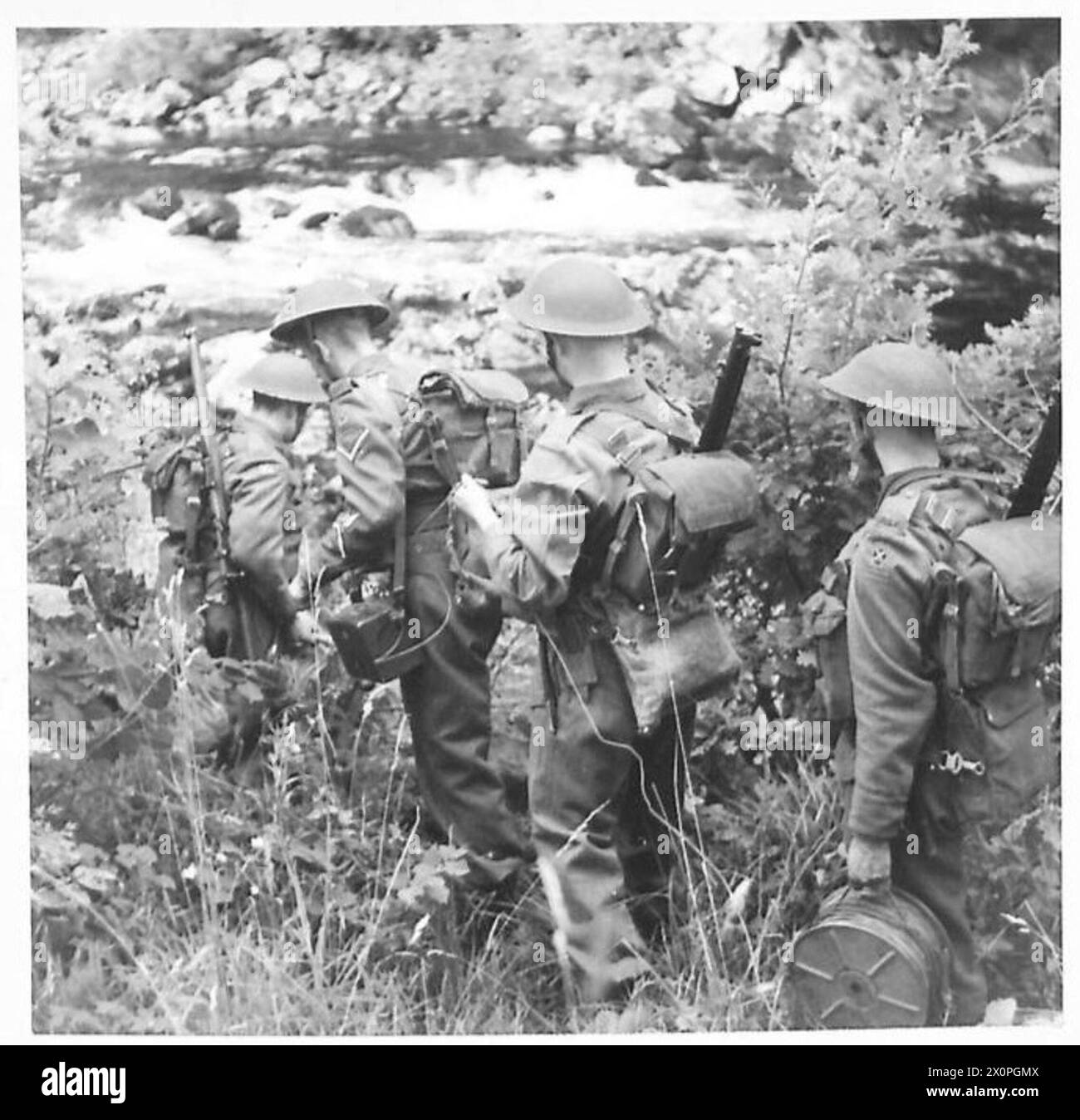 A signal platoon lays communication cable while moving to their next ...