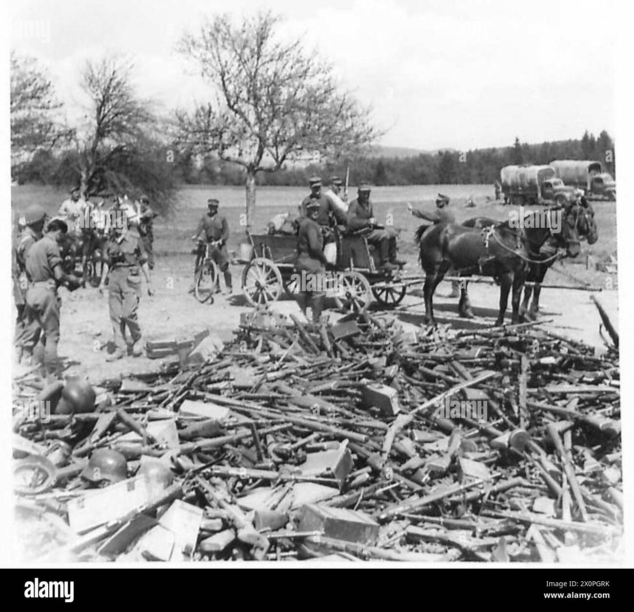 A group of Cossacks and German soldiers surrender their weapons at a ...