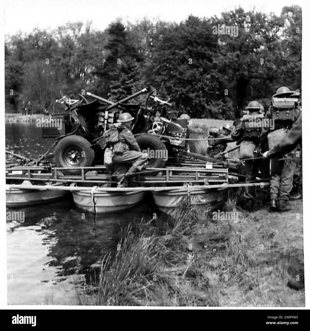 Two anti-tank guns are positioned on assault boats ready for a river ...