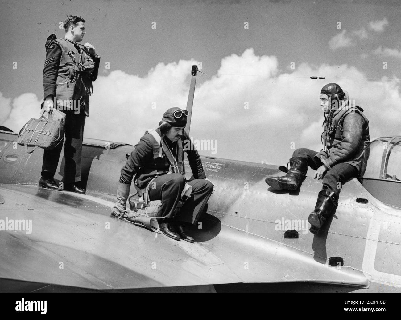 Crew members of a Bristol Blenheim Mk IV of No. 40 Squadron RAF are ...