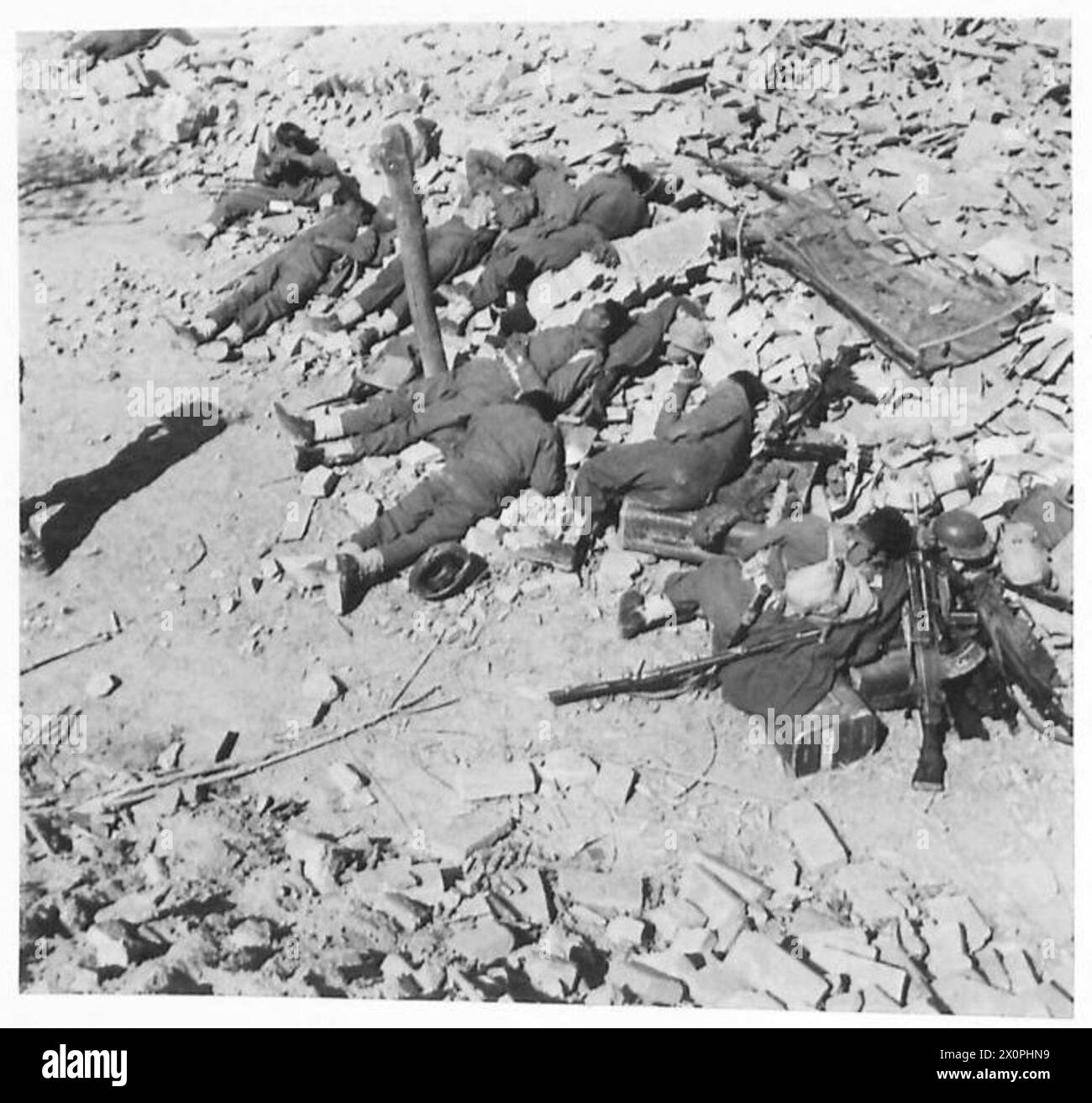 Indian troops of the 8th Indian Division take a short rest among the ...