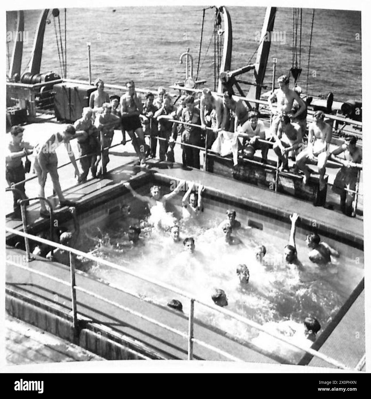 Fifth Army troops bathe in a ship’s swimming pool during the Salerno ...
