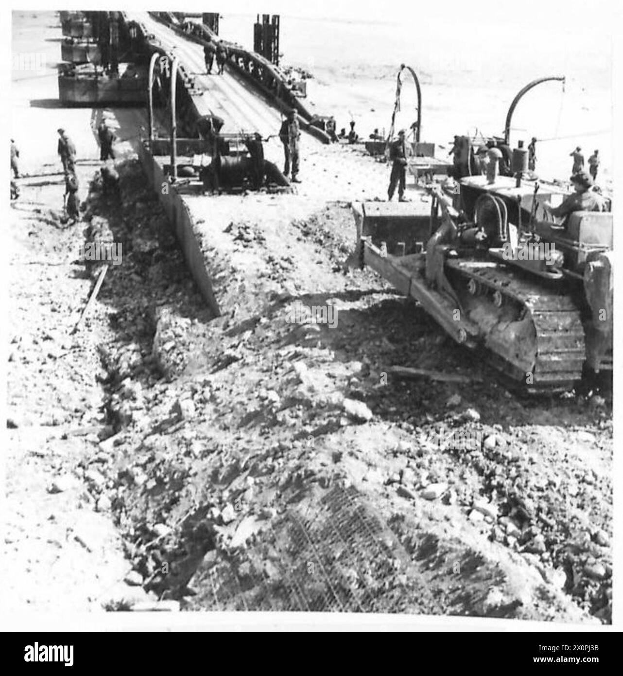 A bulldozer constructs a bolster wall along a roadway in North-West ...